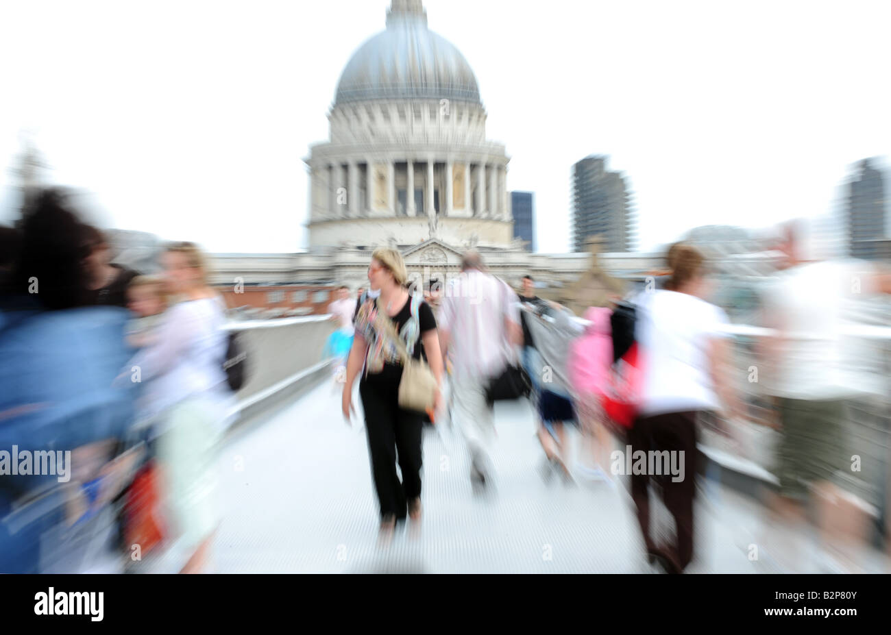 people walking over the Millennium Bridge London with st Paul's ...