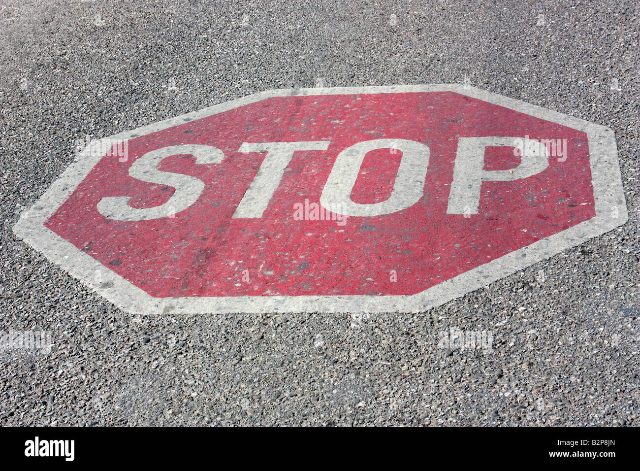 A STOP traffic sign painted on the road pavement Stock Photo - Alamy