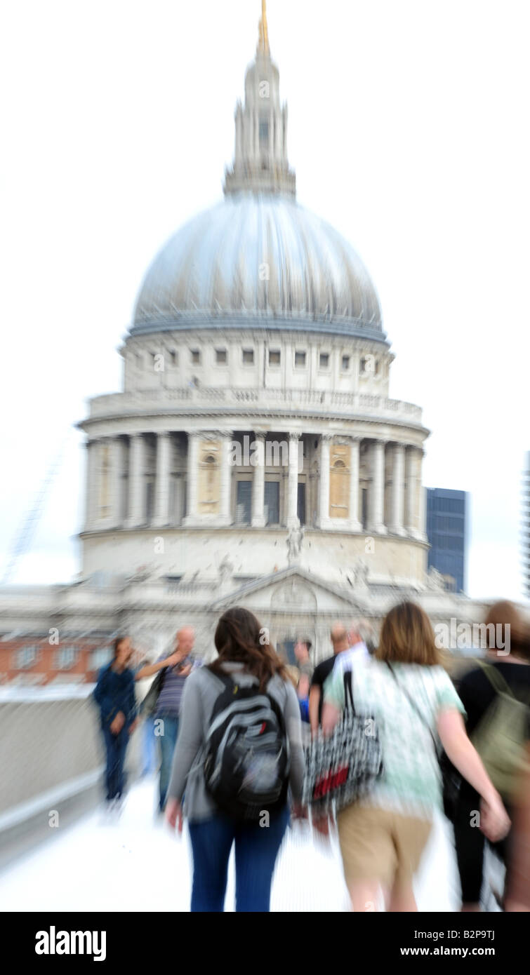 people walking over the Millennium Bridge London with st Paul's ...
