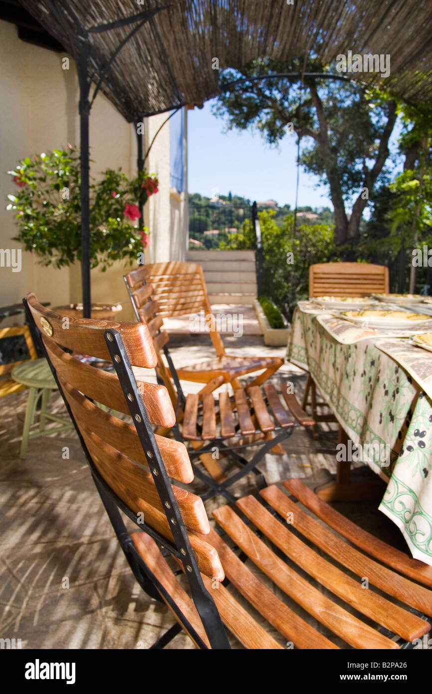 traditional mediteranean villa with table set under a bamboo cover ...