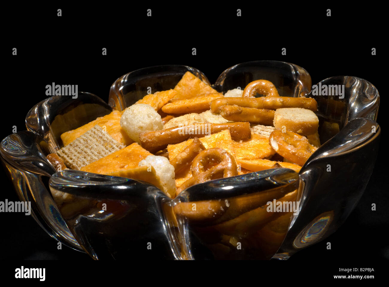 A dish of party snacks isolated against a black background Stock Photo ...