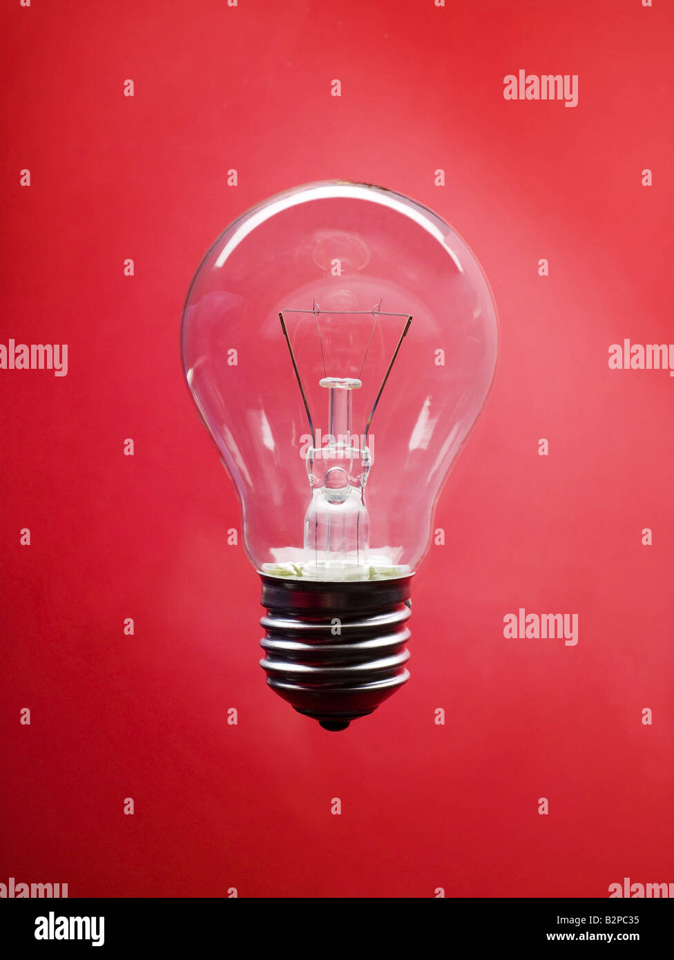 Lightbulb on red background Stock Photo - Alamy