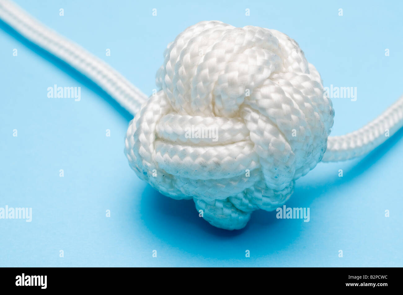 Turk s head knot on blue background used traditionally to through a ...