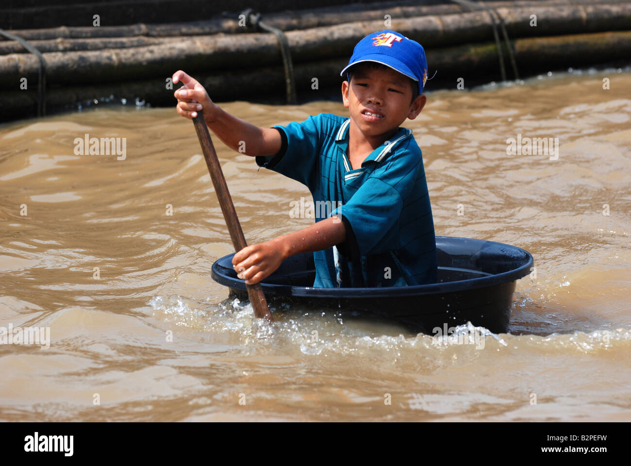 Boy rowing washing bowl Stock Photo - Alamy