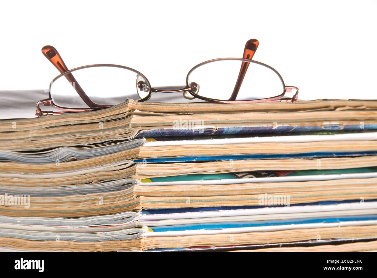 A stack of old worn magazines isolated against a white background Stock ...