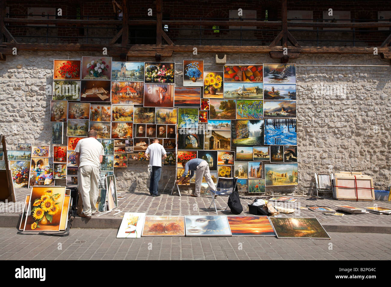 Poland Malopolska Region Krakow oil paintings hanging on old town wall ...