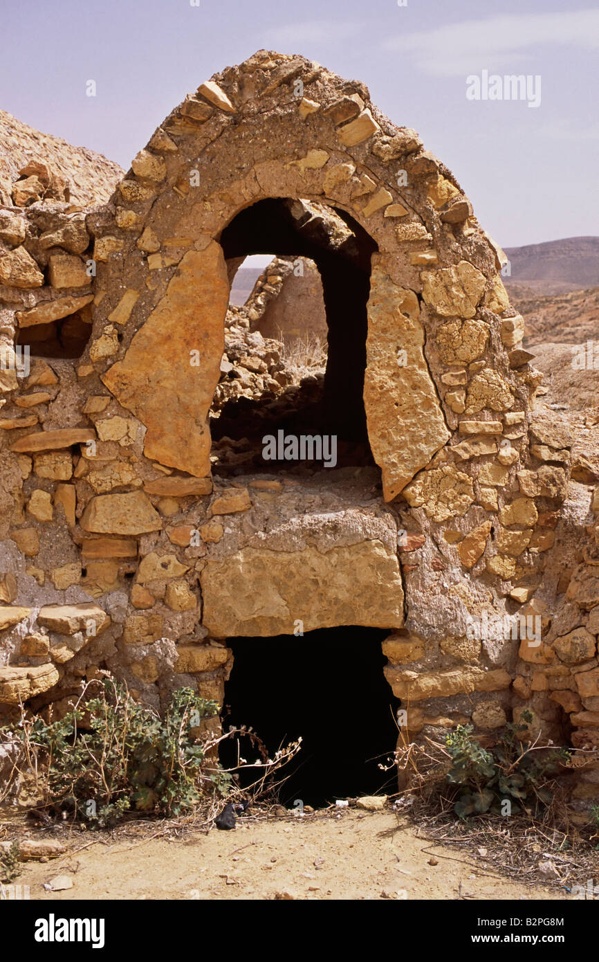 The entrance to one of the fortified granaries at Ksar El Halouf ...