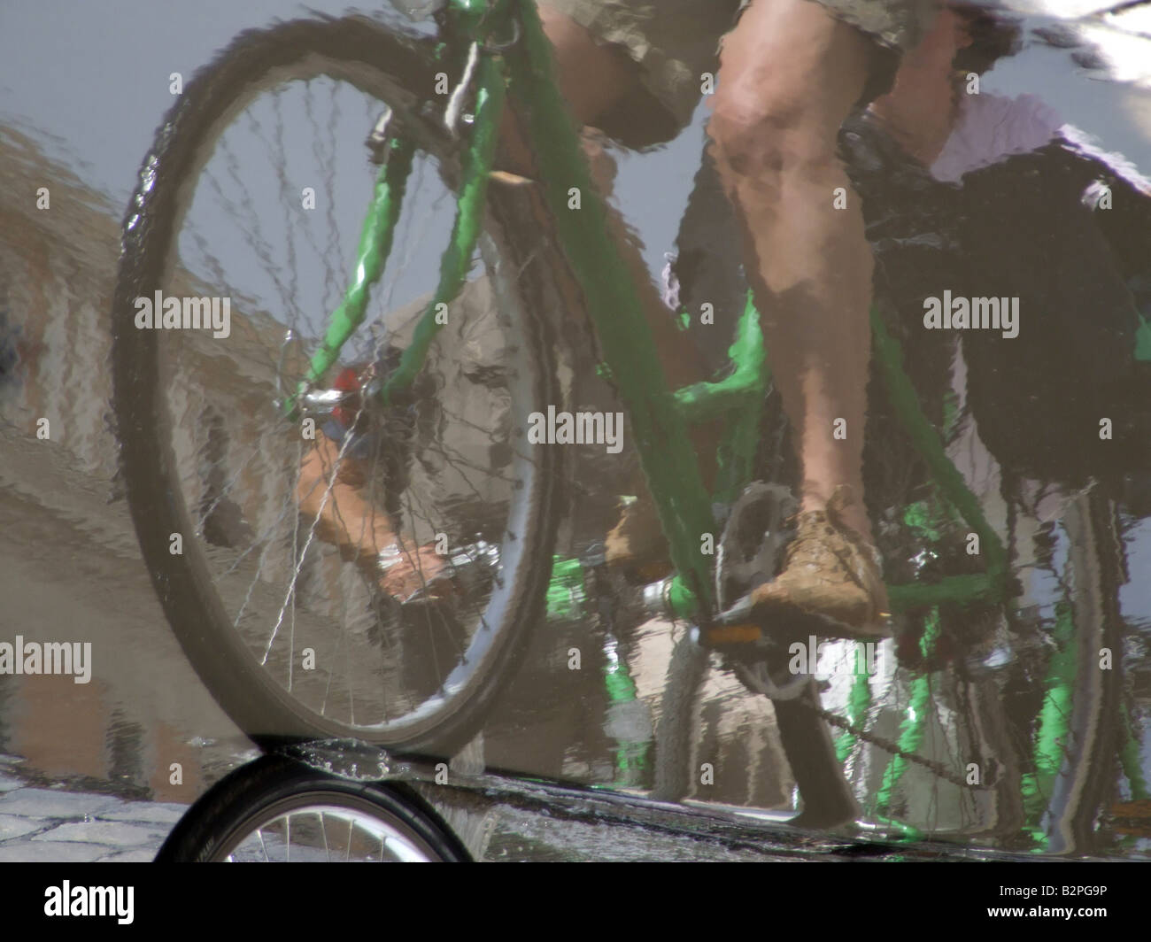 reflection of touring bike in water puddle in street road Stock Photo ...