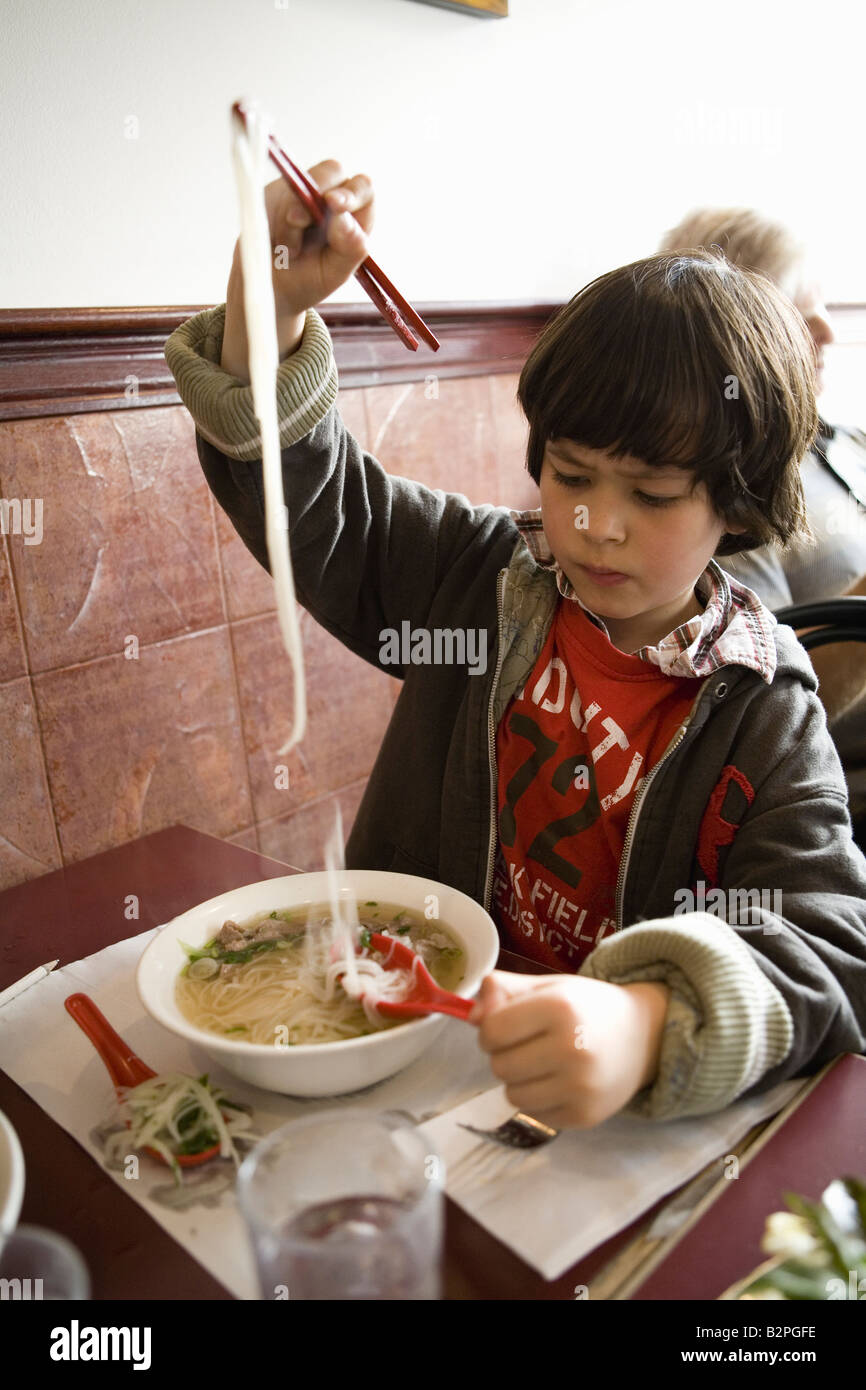 Vietnamese boy eating noodles hi-res stock photography and images - Alamy