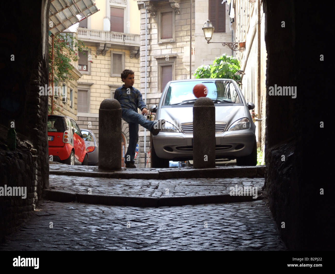 boy playing football in street in rome italy Stock Photo - Alamy