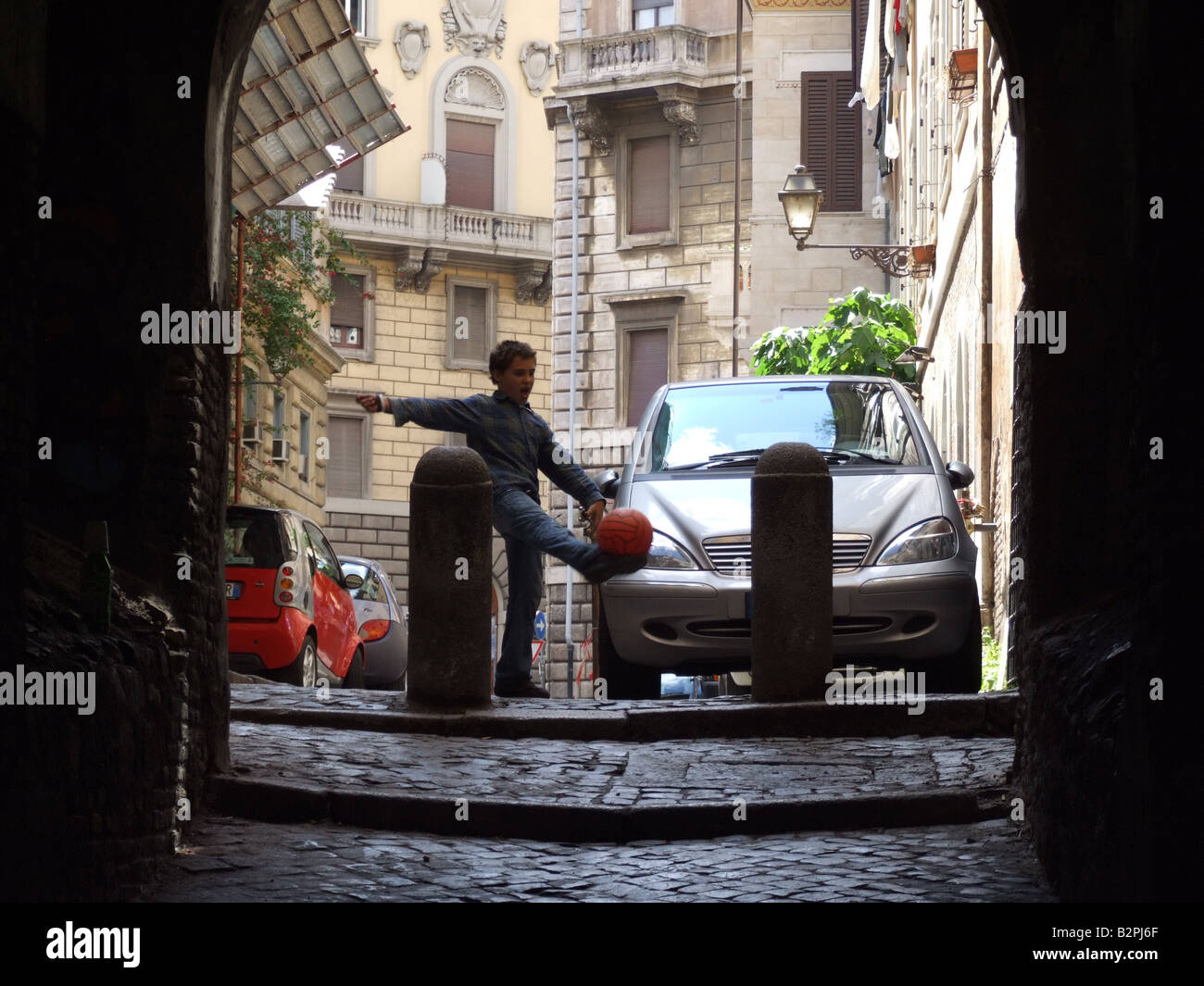 boy playing football in street in rome italy Stock Photo - Alamy