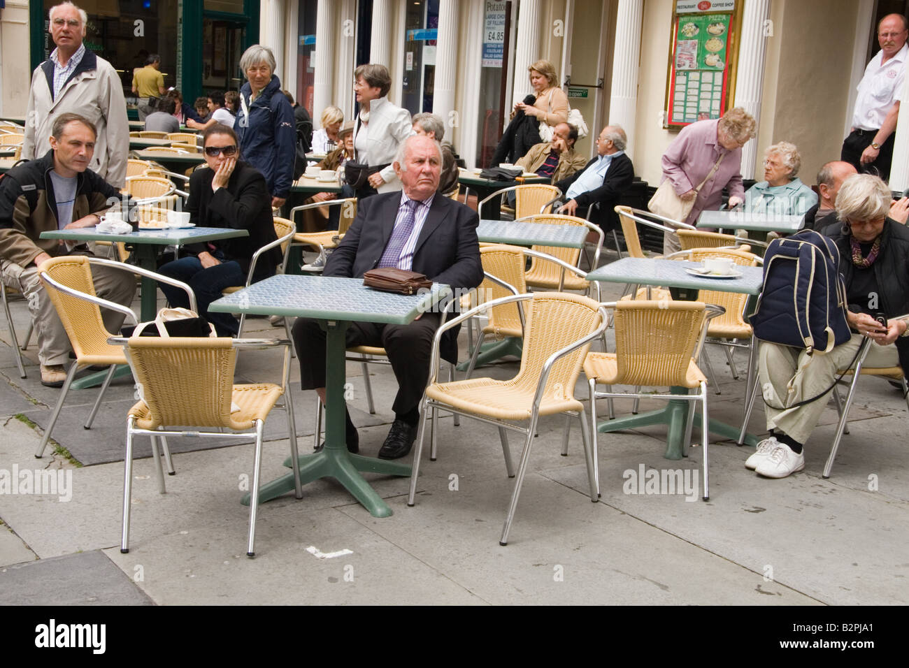 People sitting at cafe tables, Abbey Church Yard Bath Somerset UK Stock ...