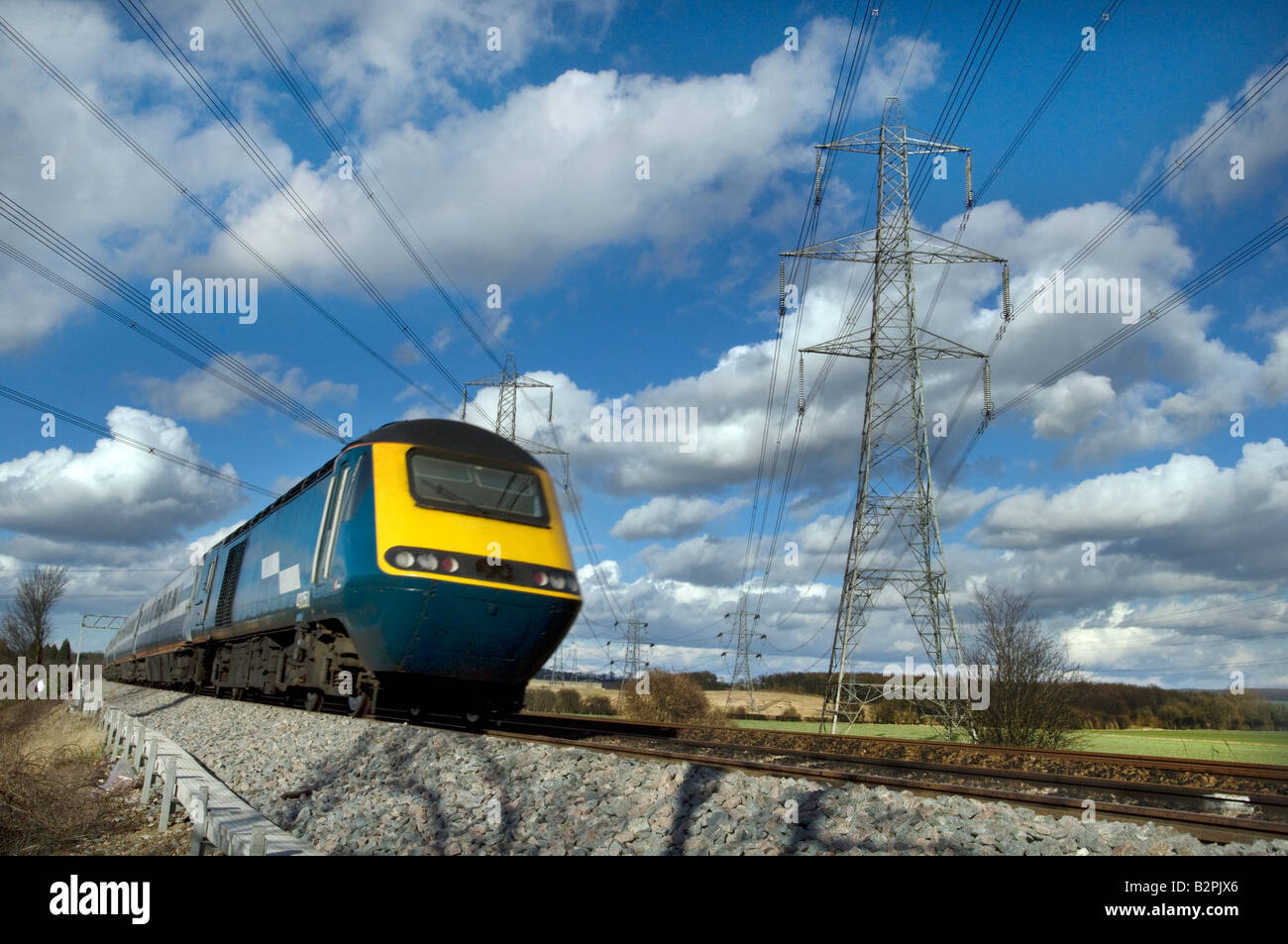 A high speed train passes an electricity pylon Stock Photo - Alamy