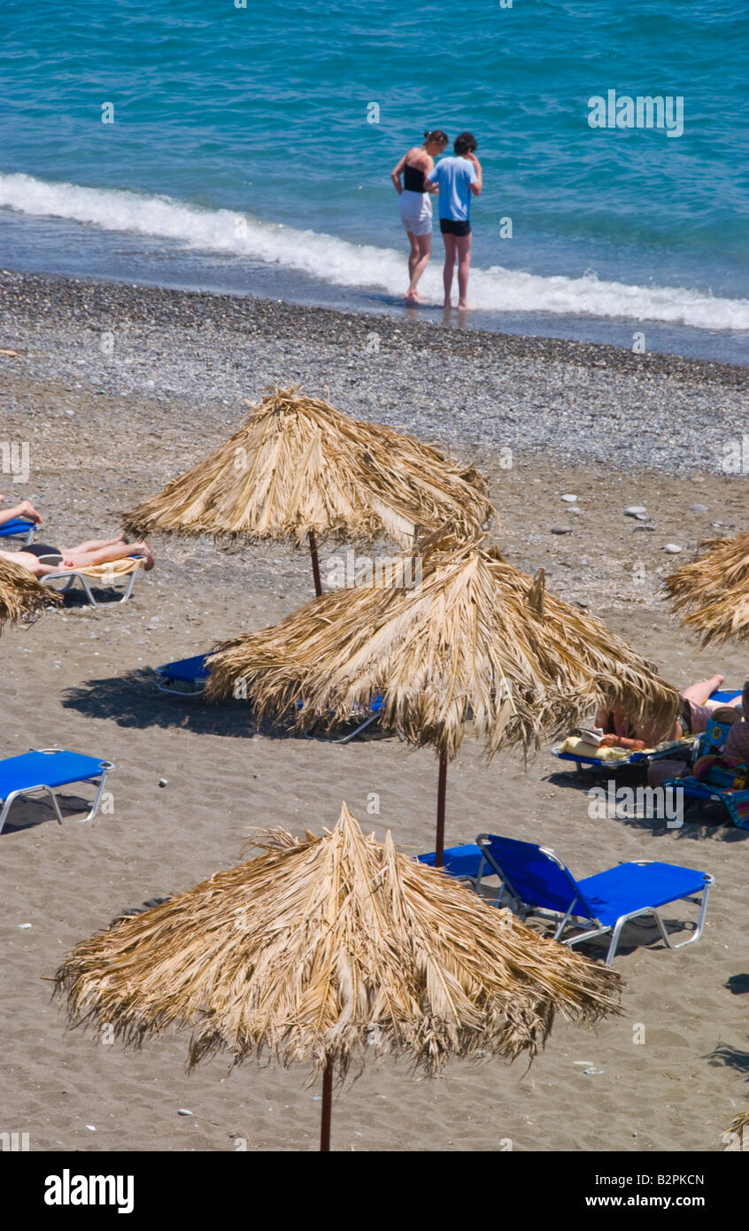 People relax on the beach at Myrtos on the Greek Mediterranean island ...