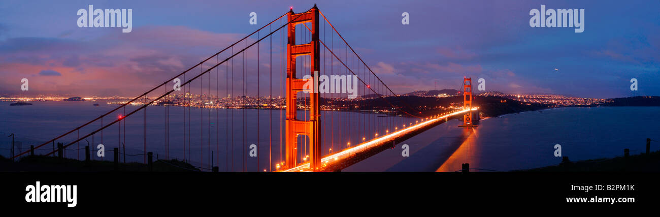 Glowing Golden Gate bridge on a stormy evening in winter Stock Photo ...