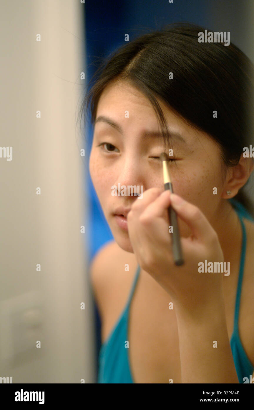 Chinese woman applying eye shadow girls night out Stock Photo - Alamy