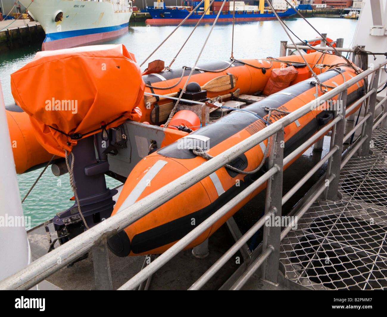 Small orange dinghy with outboard motor on a cross channel ferry UK ...