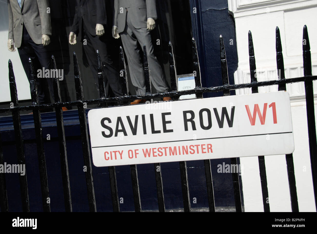 Saville Row street sign on railings outside tailors shop Mayfair London ...