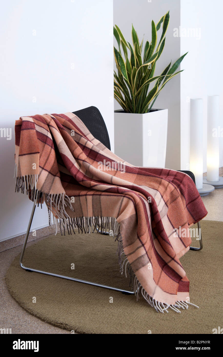 Plaid draped over a chair Stock Photo - Alamy