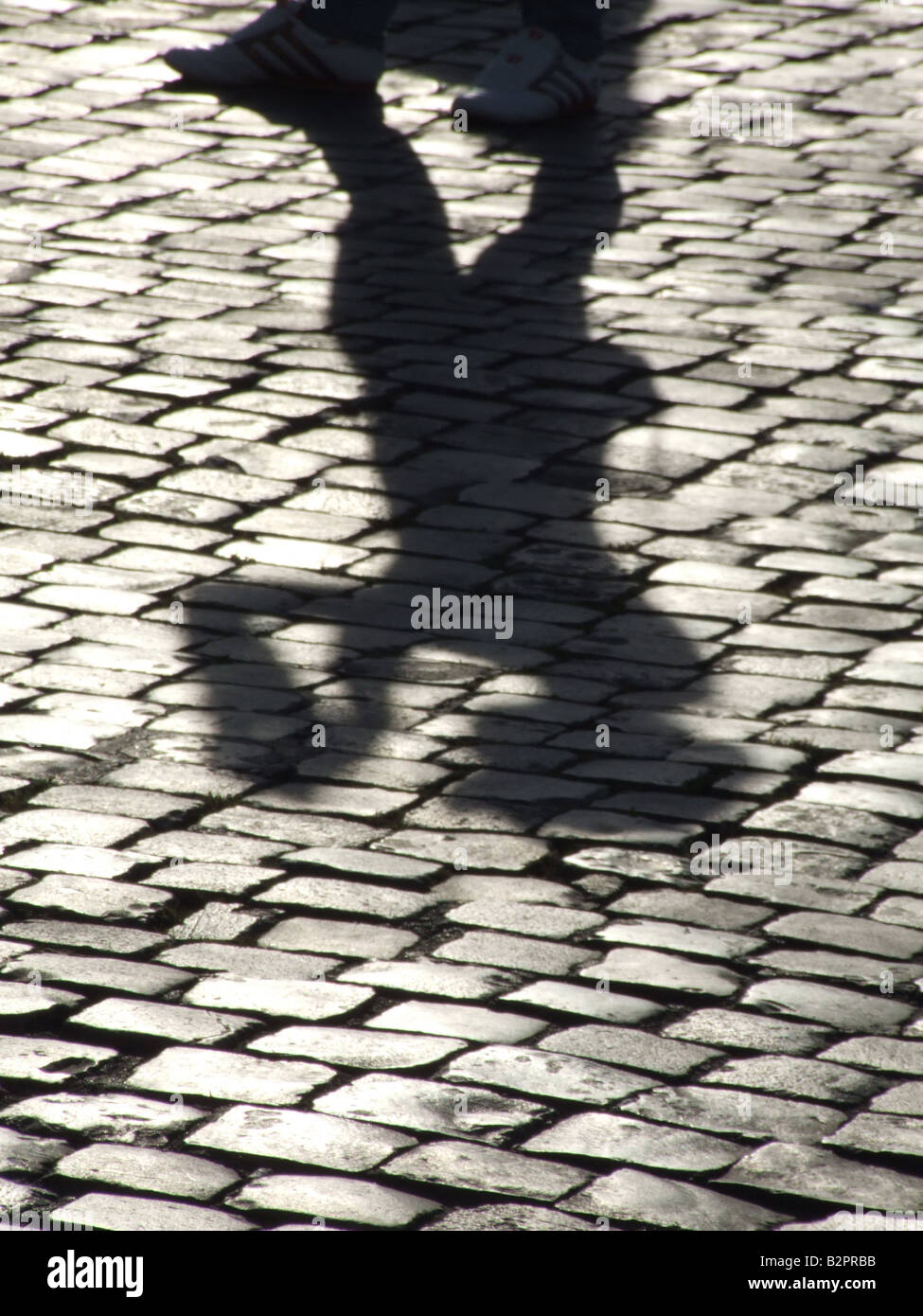 shadow of person on street road in city town Stock Photo - Alamy