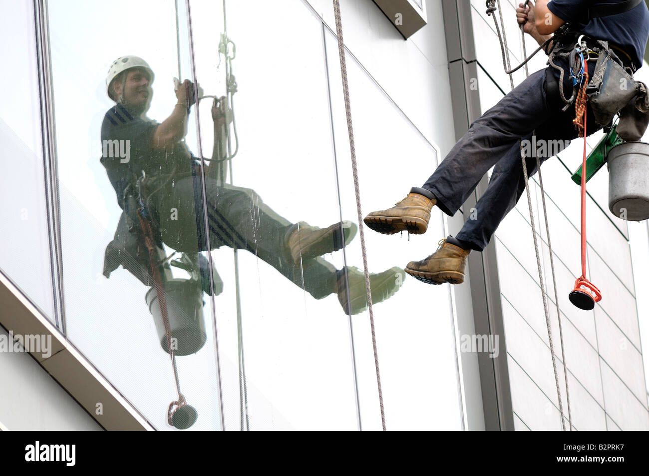 Abeiling window cleaners on tower block Stock Photo - Alamy