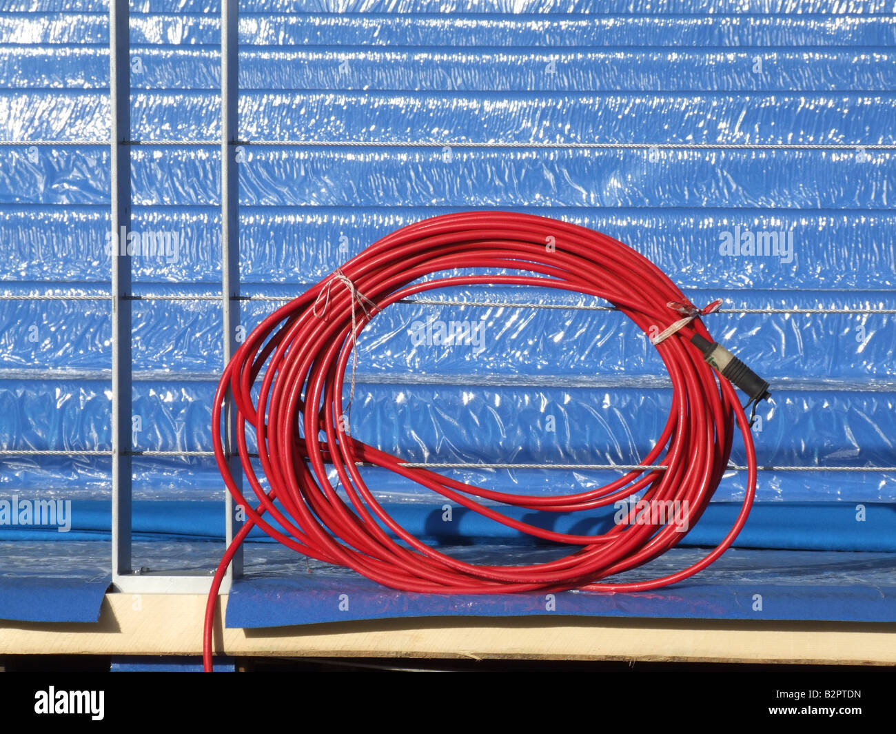 blue steps with plastic cover and red cable coil Stock Photo - Alamy