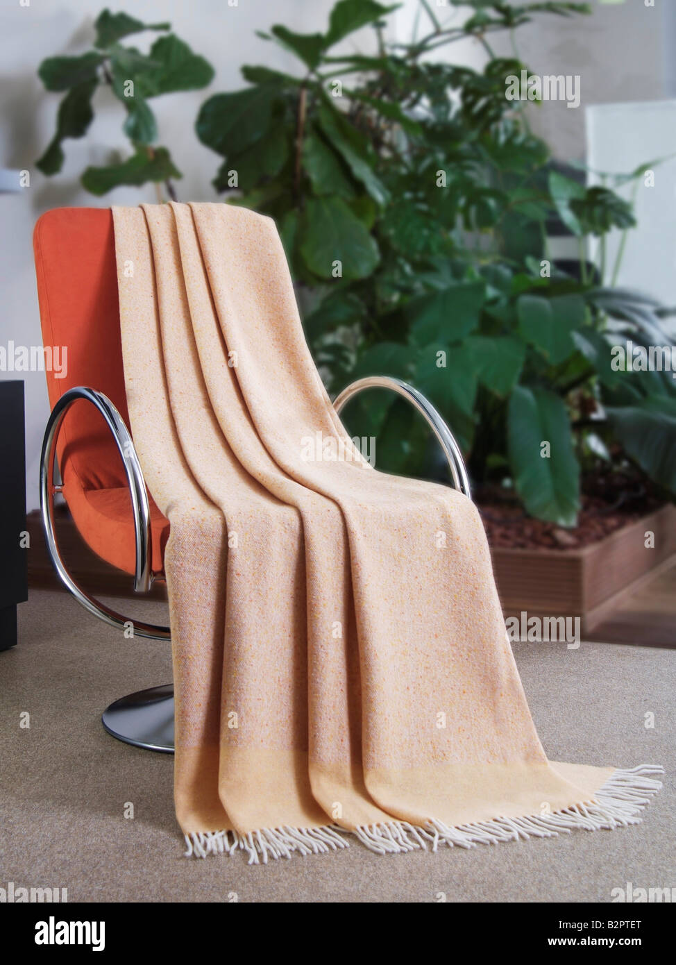 Throw draped over a chair Stock Photo - Alamy