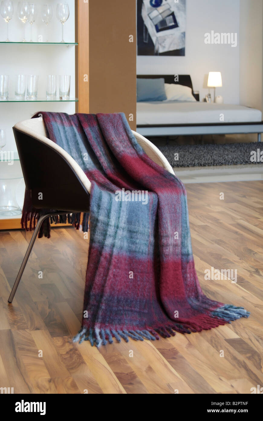 Plaid draped over a chair Stock Photo - Alamy