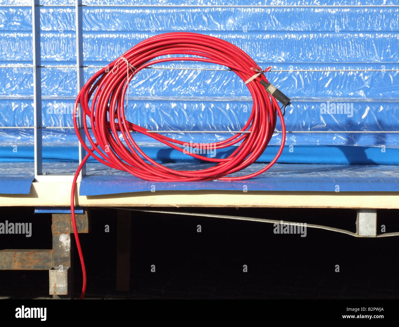 blue steps with plastic cover and red cable coil Stock Photo - Alamy