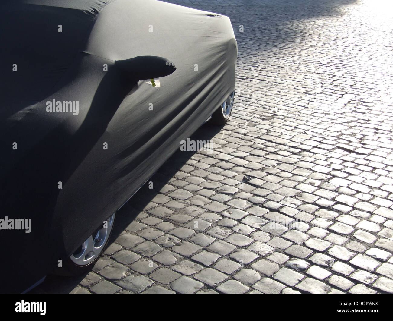 car covered with grey tarpaulin sheet in street Stock Photo - Alamy