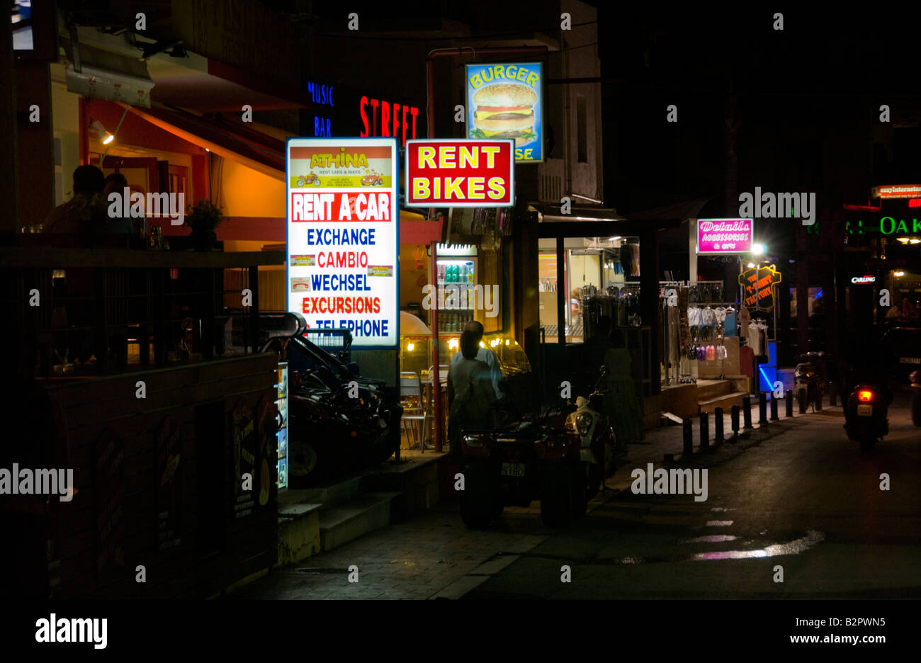 Shops and fast food at night in Malia on the Greek Mediterranean island ...