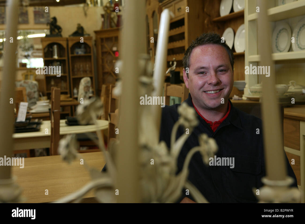 a furniture craftsman sits with some of his handywork around him Stock ...