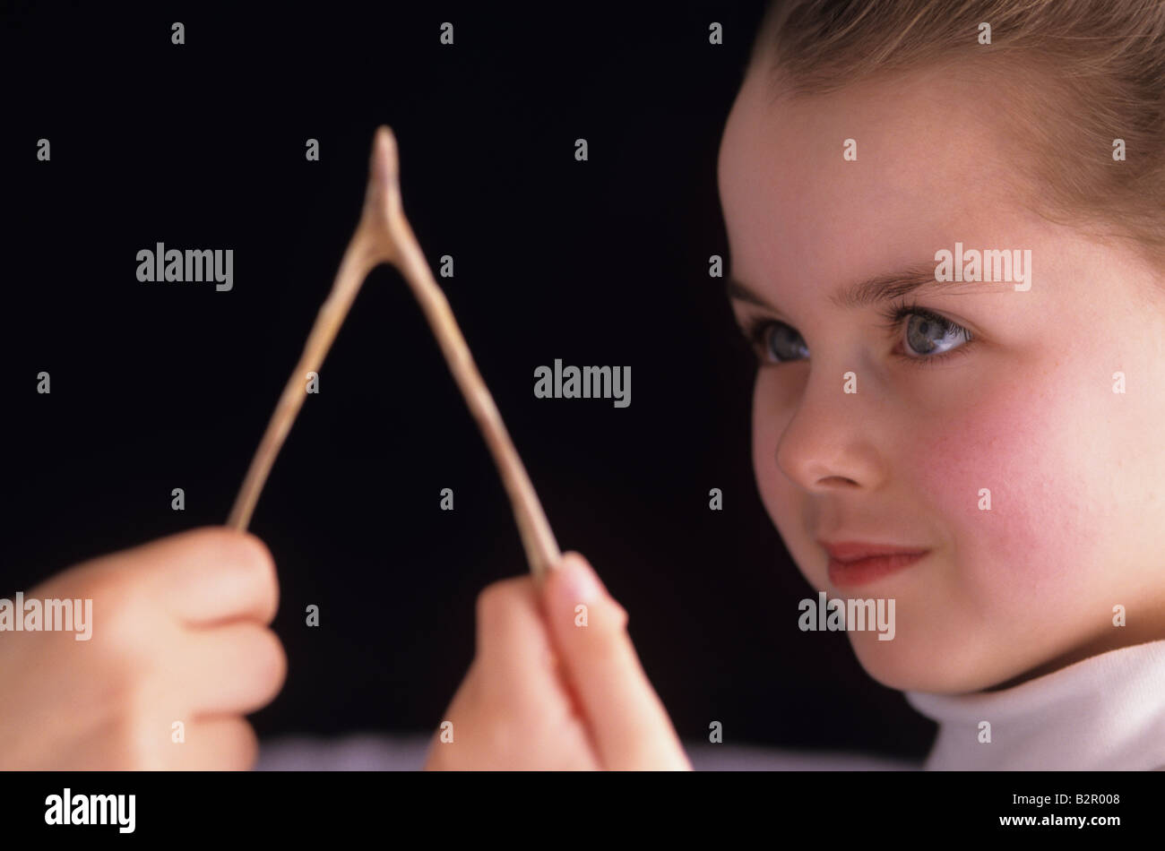 Mother and daughter pulling on a wishbone close up of hands Stock Photo ...