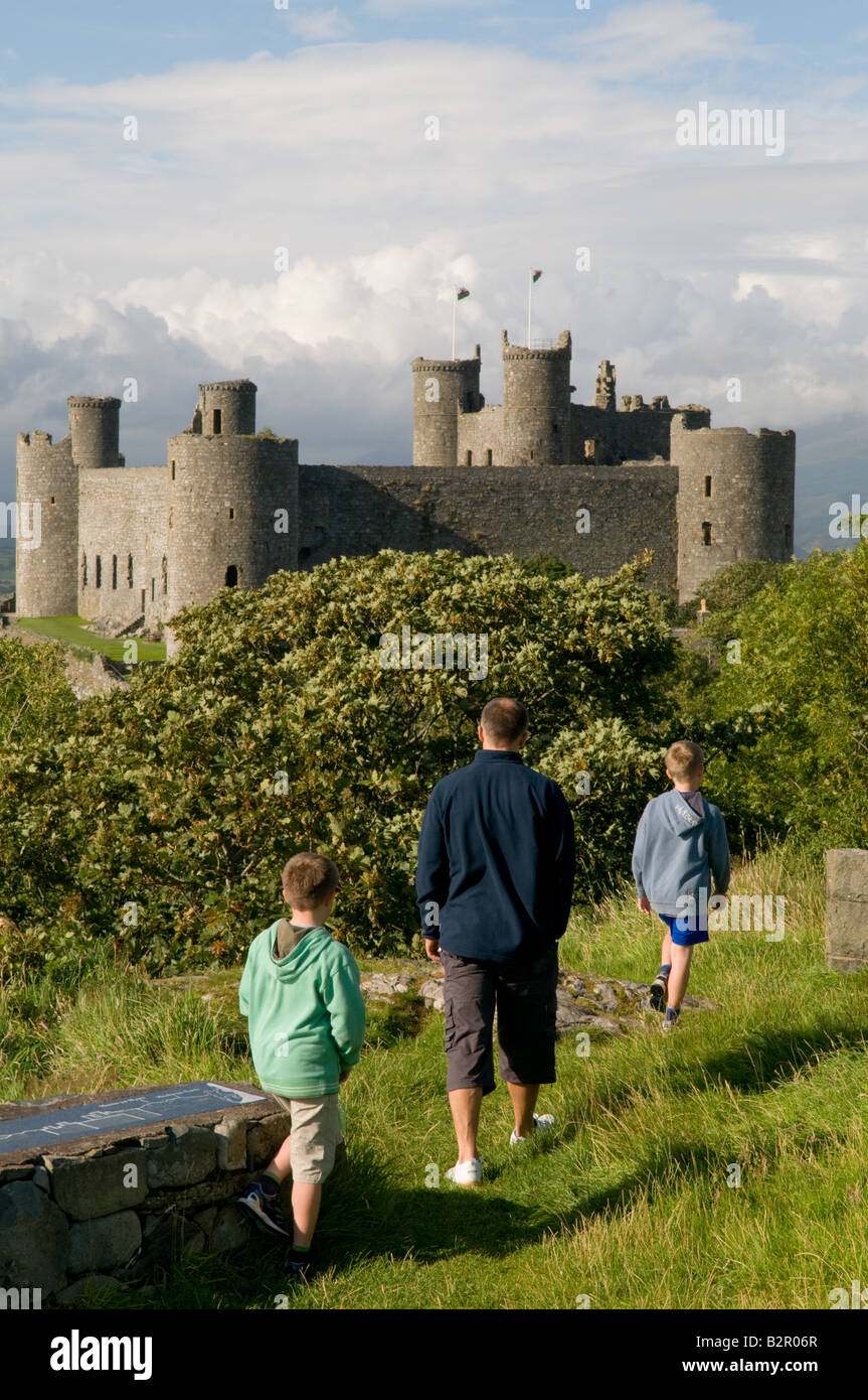 Family of tourists sightseers on holiday looking at Harlech Castle ...