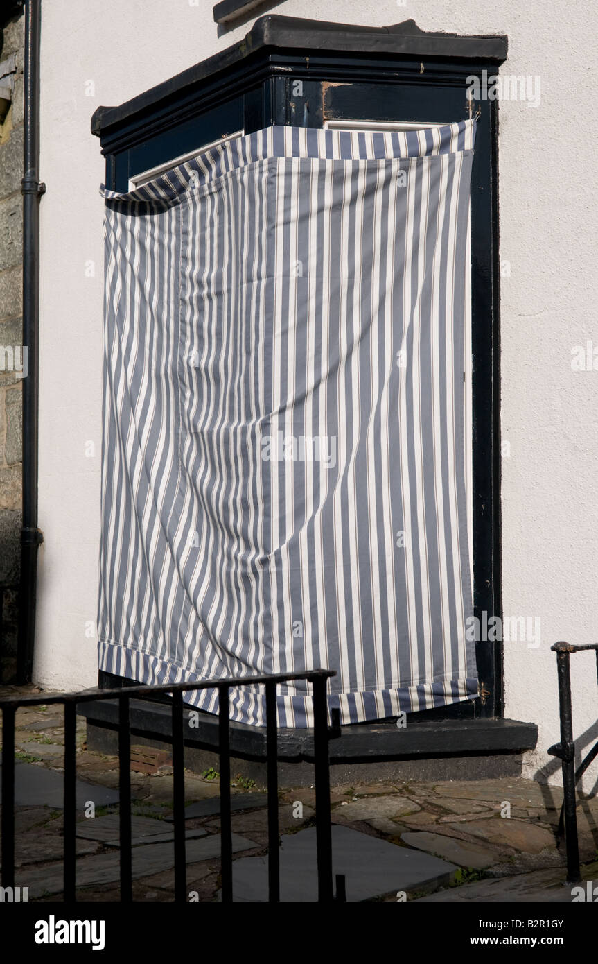 old fashioned striped canvas window covering on bay window of house, UK ...