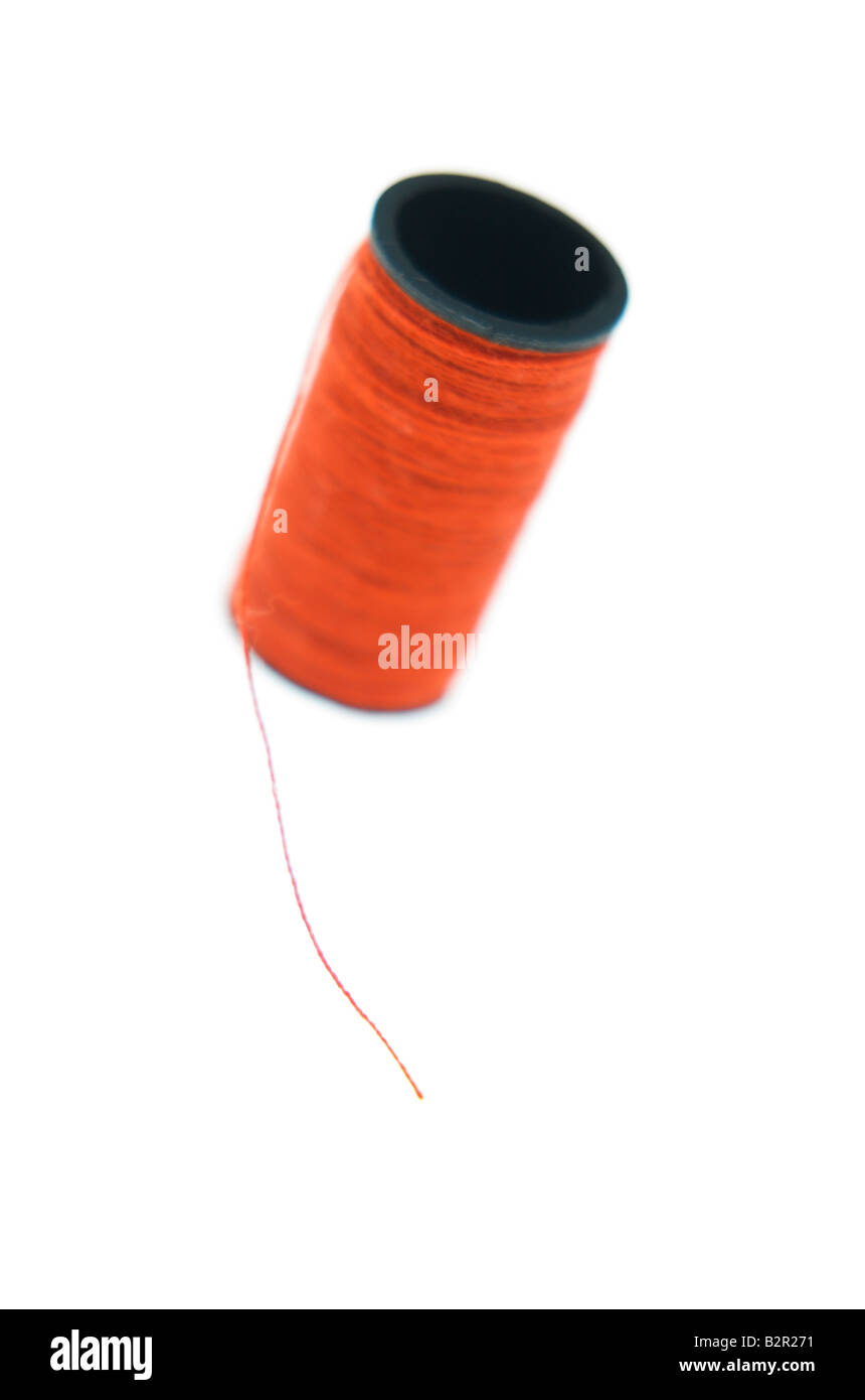 red thread on spool Stock Photo - Alamy