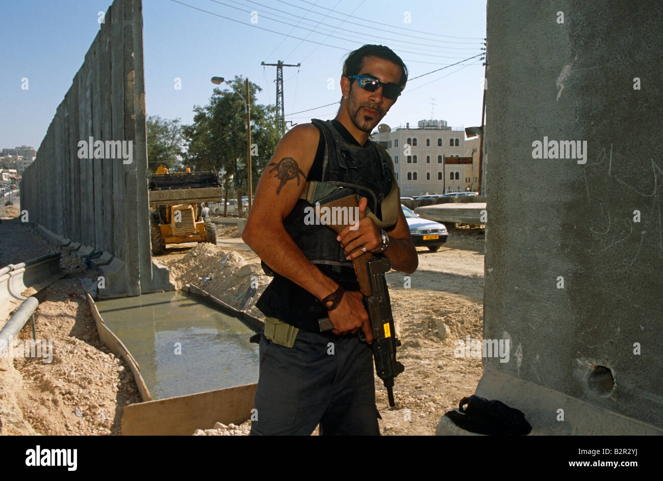 Armed man guarding the Wall, East Jerusalem Stock Photo - Alamy