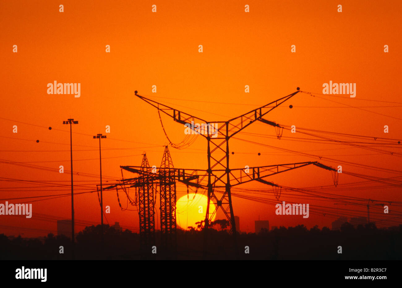 Sunset over pylon towers Stock Photo - Alamy