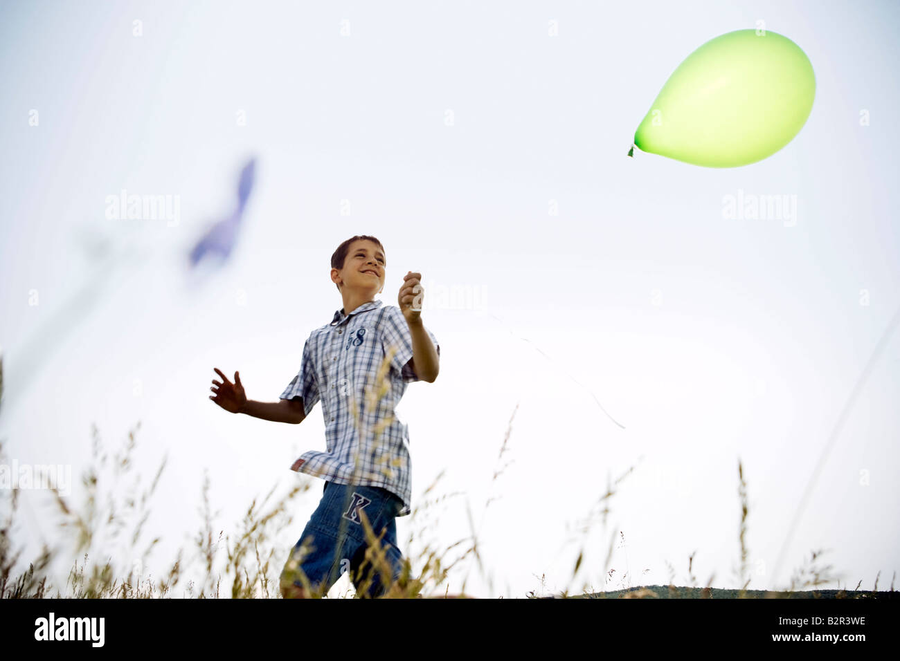 Boy running with balloon Stock Photo - Alamy