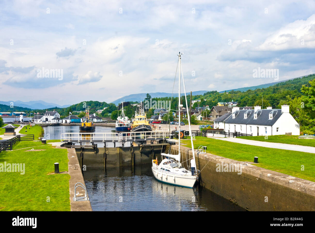 A yacht is progressing north through locks in the Caledonian Canal at ...