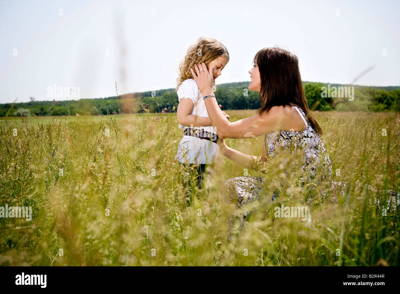 Mother talking to daughter Stock Photo - Alamy