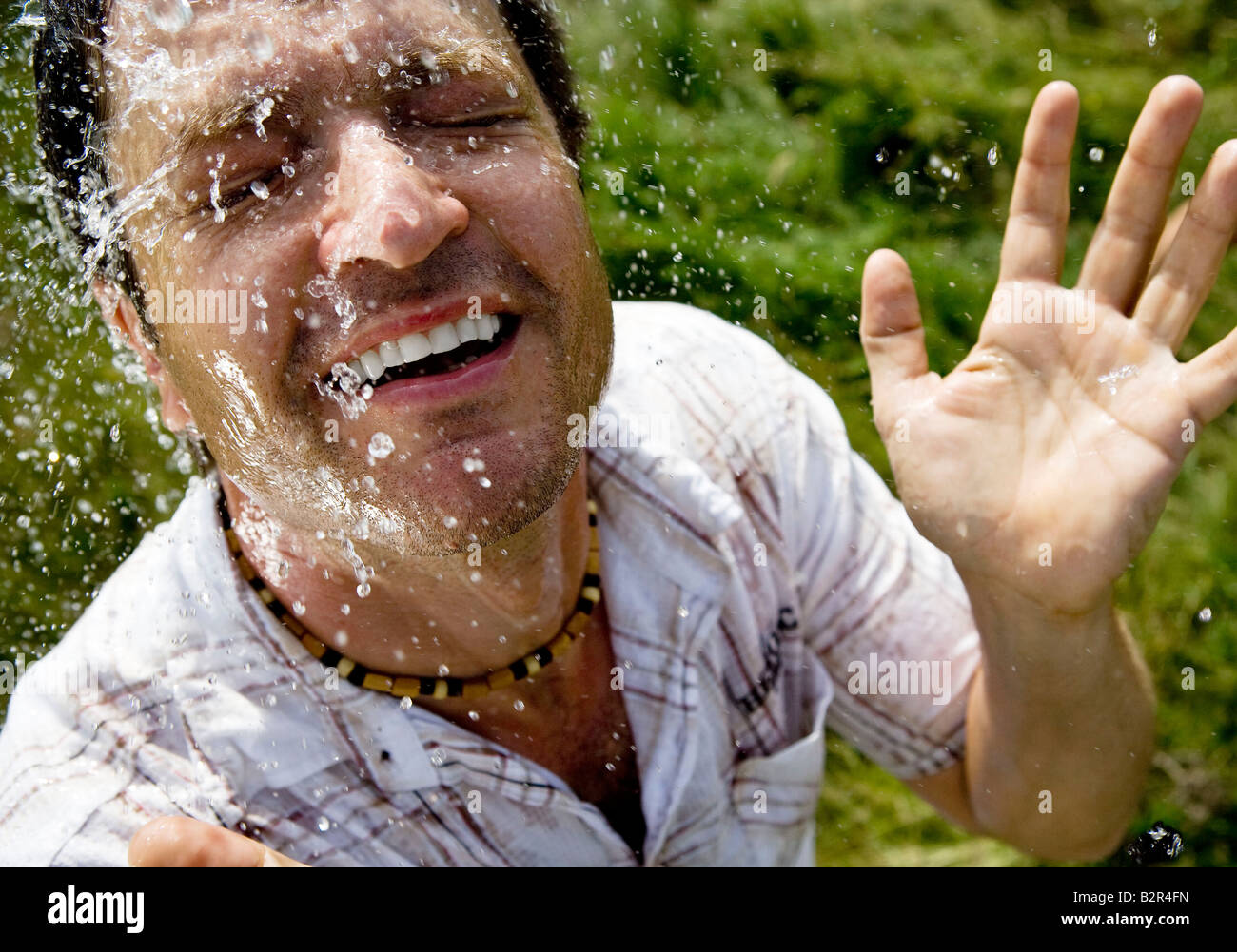Man splashed with water Stock Photo - Alamy