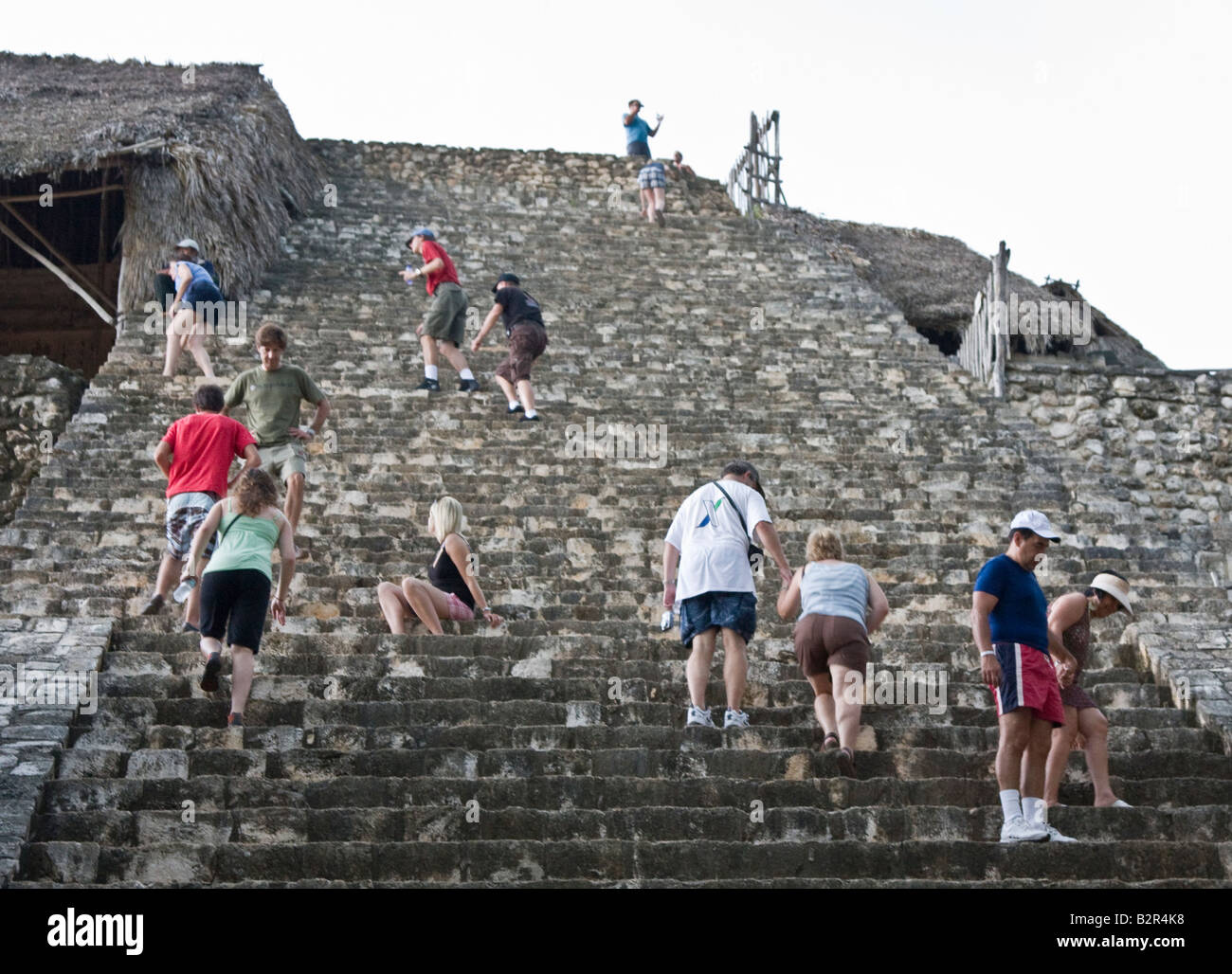 Tourists climb the pyramid of Acropolis structure at Ek Balam, Mexico ...