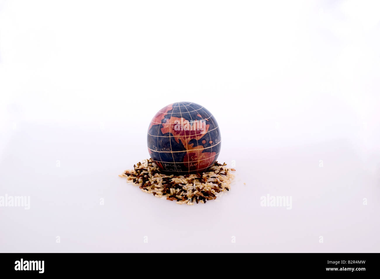 Small earth globe atop a mound of uncooked wild rice Stock Photo - Alamy