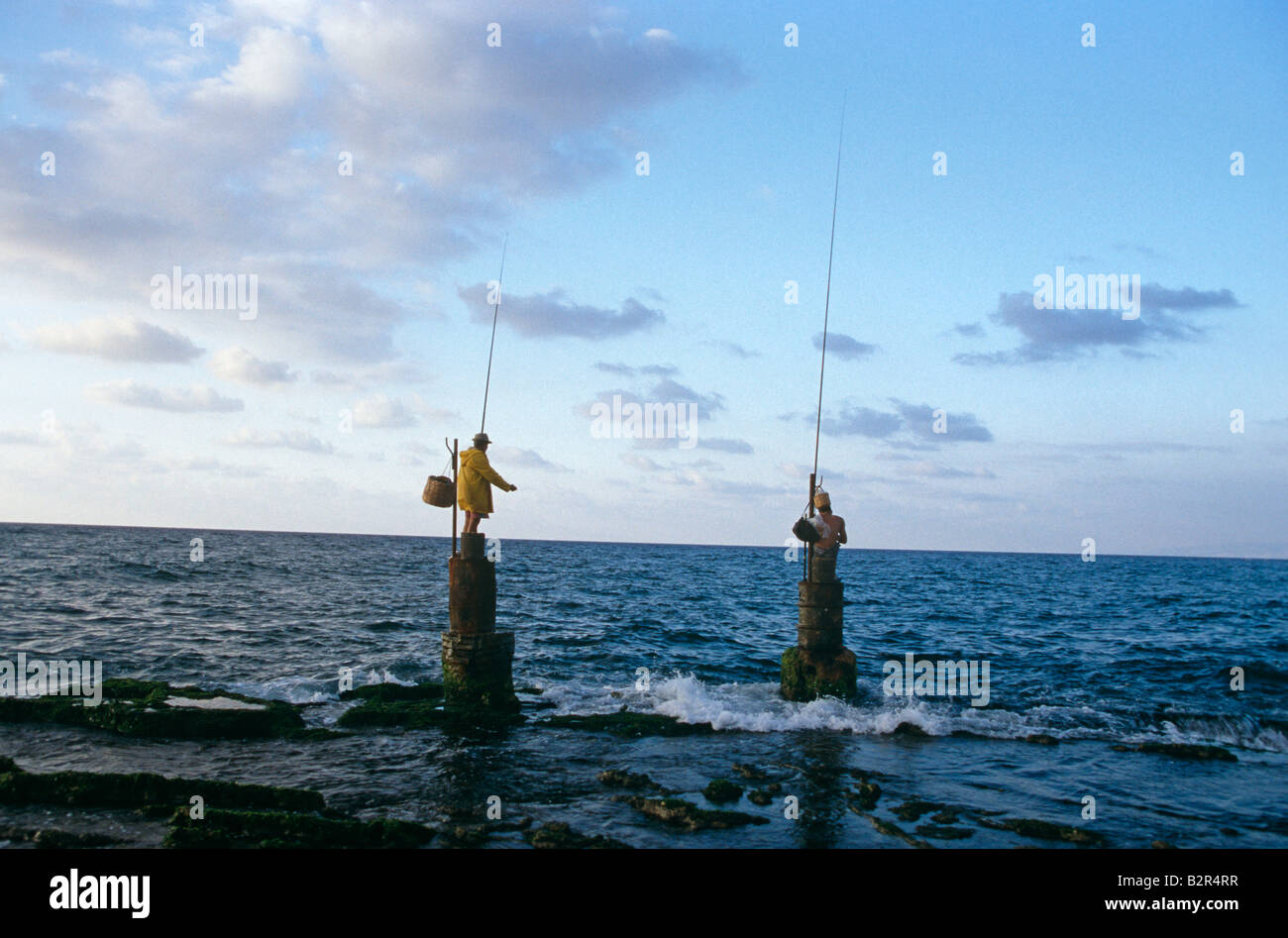 Fishermen fishing from top of barrels in sea, Beirut, Lebanon, Middle ...