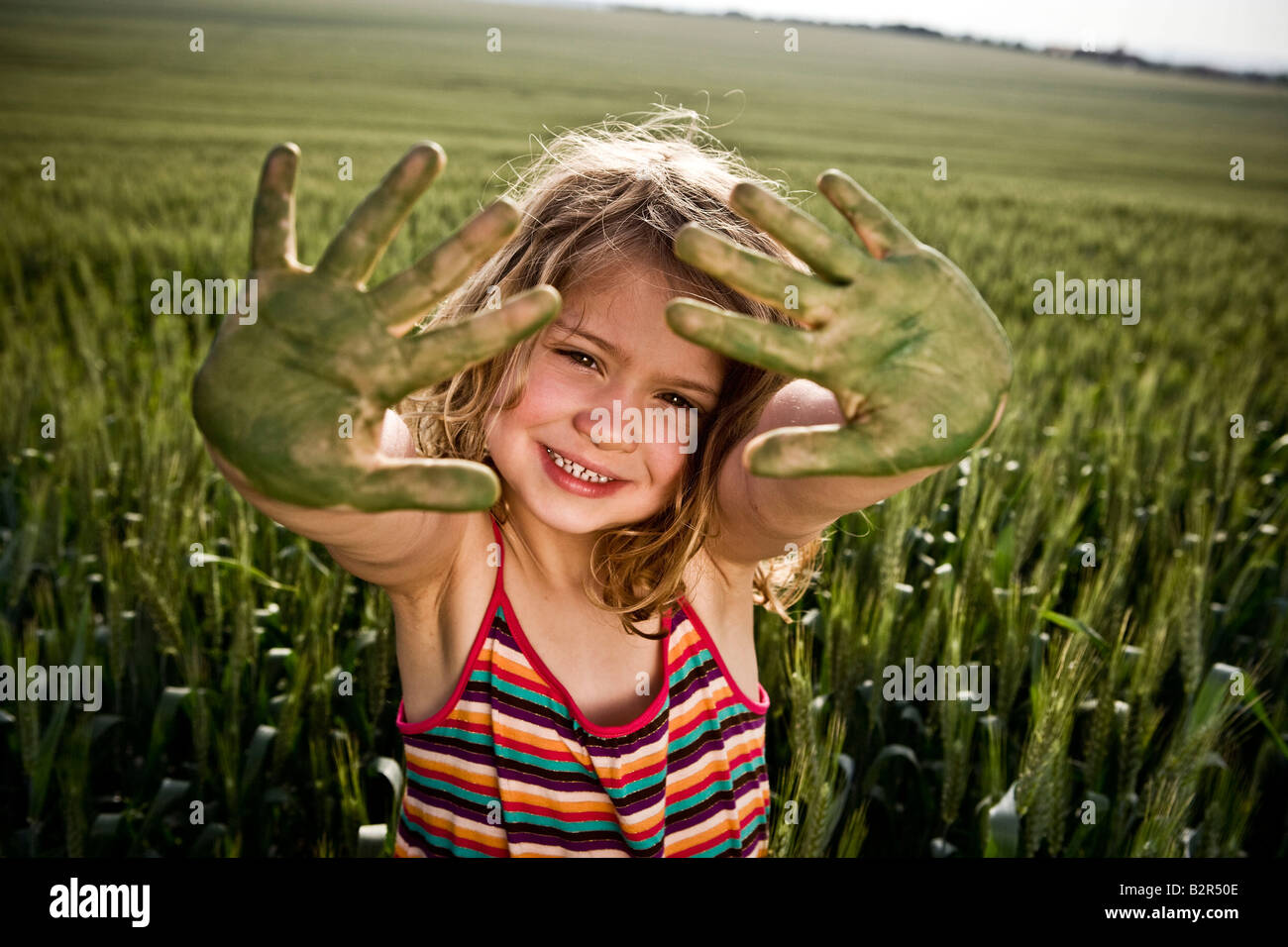 Girl with painted green hands Stock Photo - Alamy
