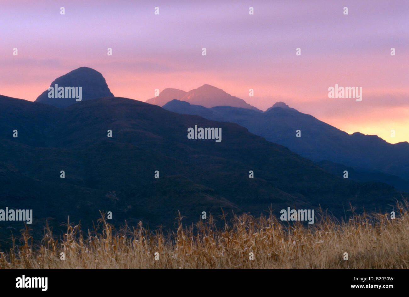 Scenic landscape with silhouetted mountain range at sunset, Lesotho ...
