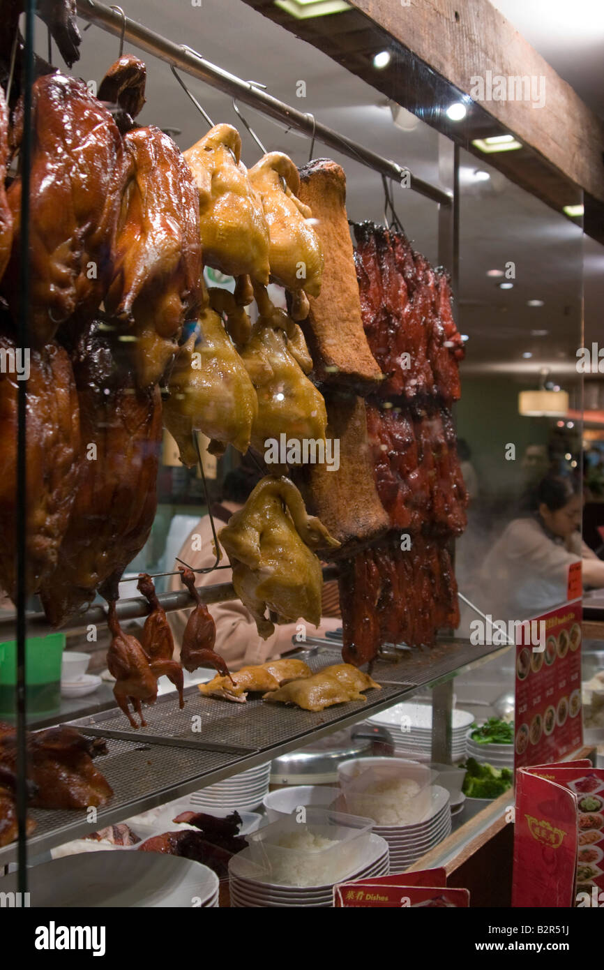 Roasted fowl hanging in food court of Singapore shopping district ...