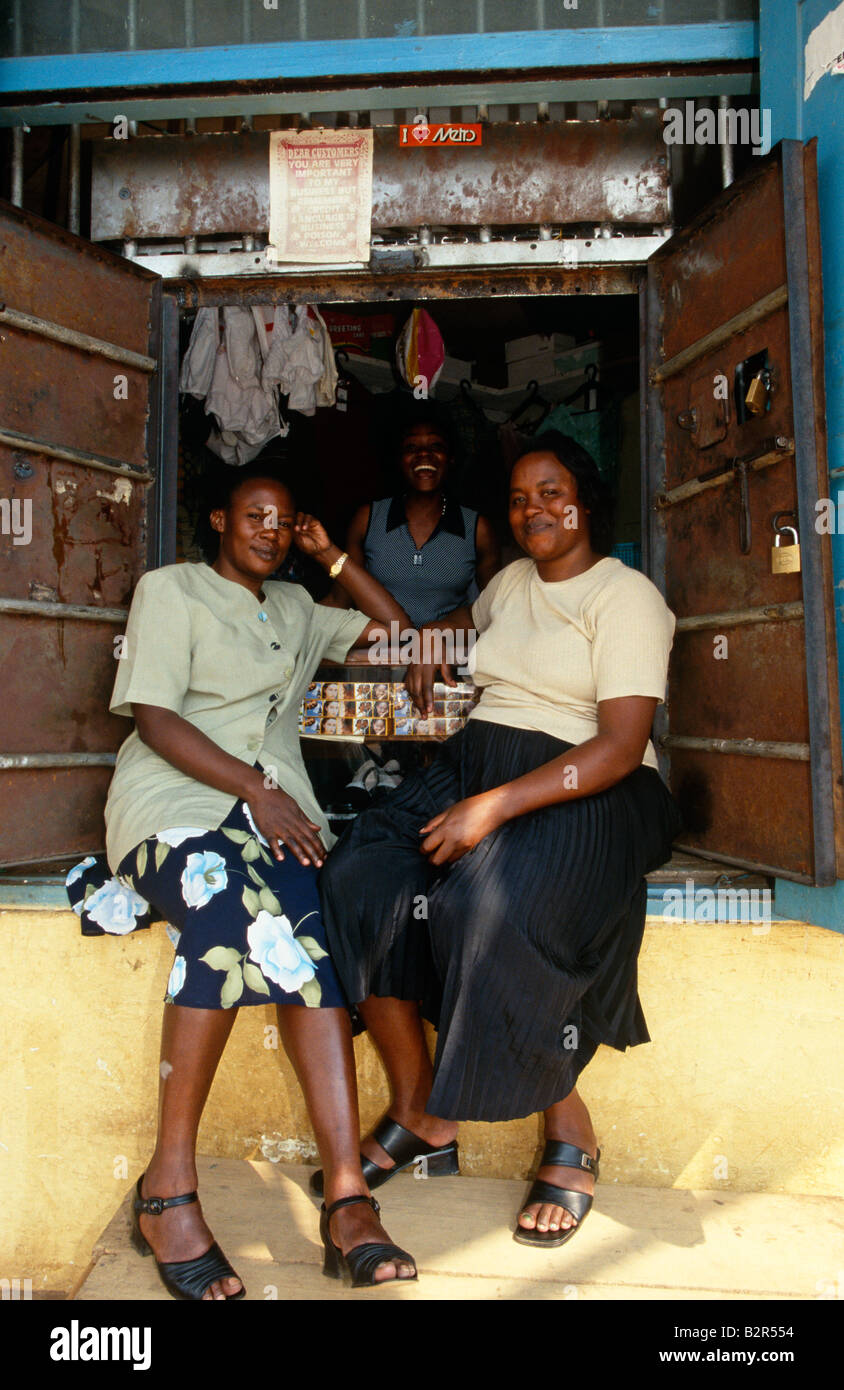 Shopkeeper with friends at stall, Malawi, Africa Stock Photo - Alamy