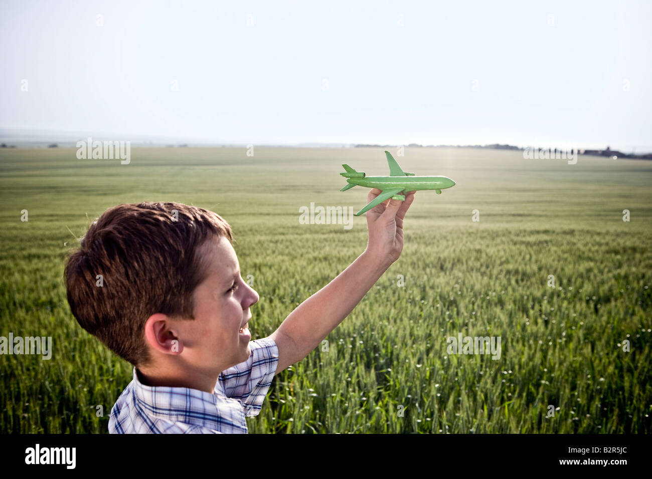 Boy playing with toy plane Stock Photo - Alamy